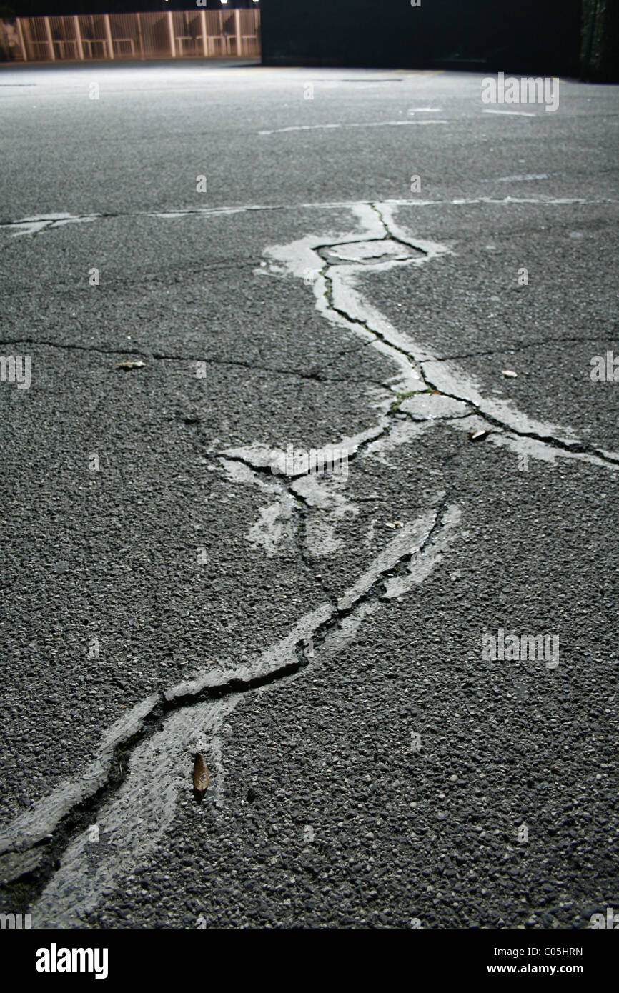 damaged street surface at night in city town Stock Photo - Alamy
