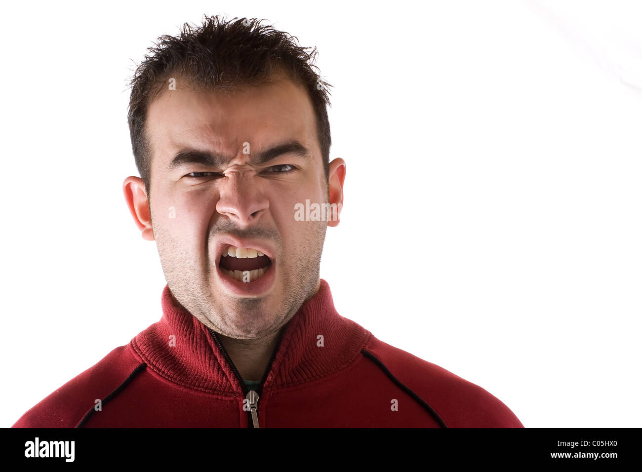 Young man isolated over white with a disgusted look on his face Stock ...