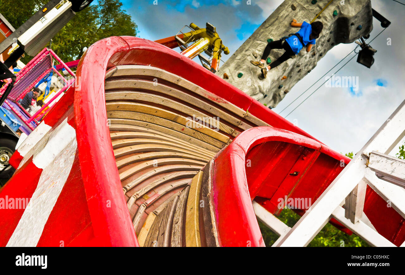 A bright red helter skelter ride at a funfair or carnival Stock Photo ...