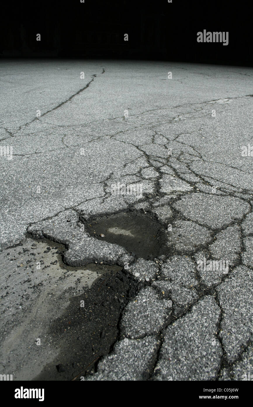 damaged street surface at night in city town Stock Photo - Alamy