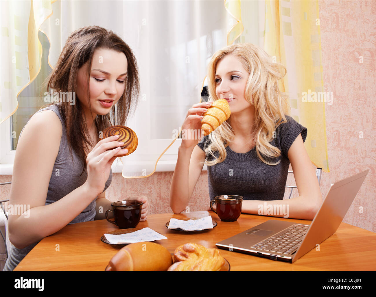 two girls drinking tea Stock Photo - Alamy