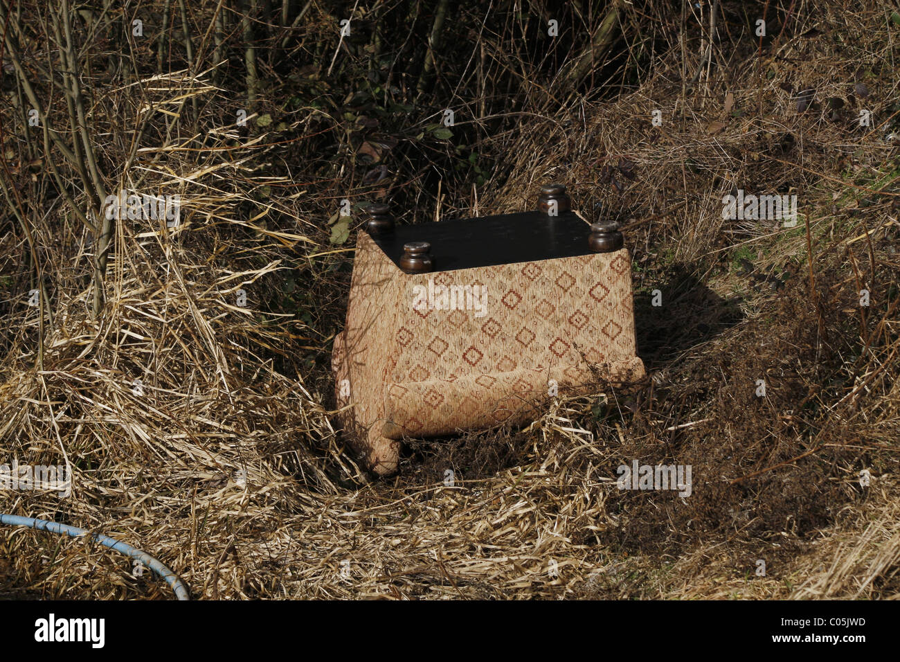 fly tipping of sofa chair Stock Photo - Alamy