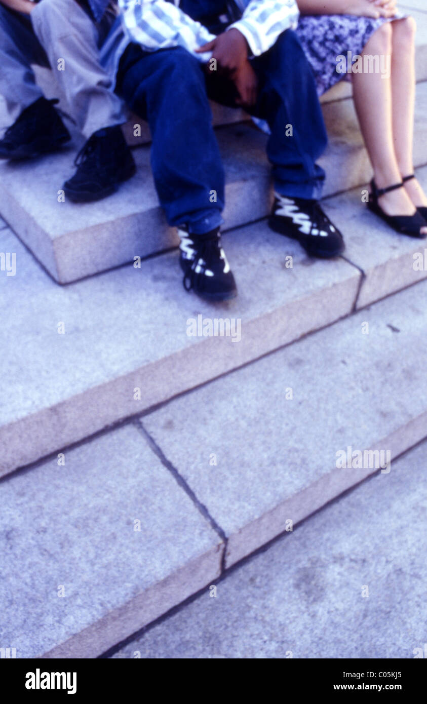 bottom portion of three children sitting on stone steps Stock Photo - Alamy