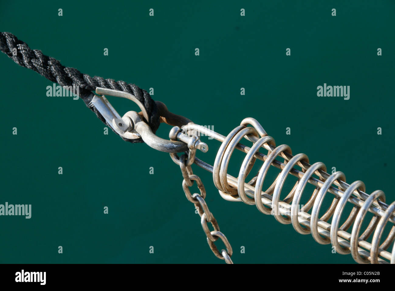 detail of mooring rope with metal steel spring for boat yacht in port ...