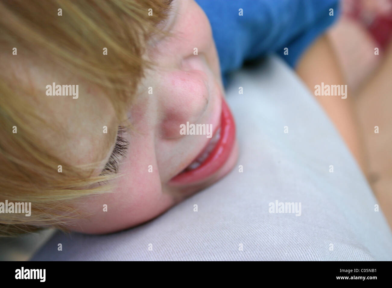 Two year old child clinging to parent, crying. Parent's perspective ...