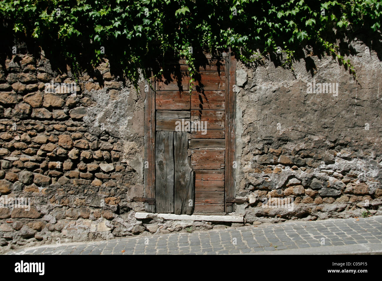 Old wooden door on street in rome hi-res stock photography and images ...