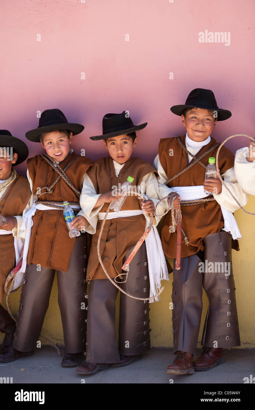 Three school children dressed in cowboy costume while participating in ...