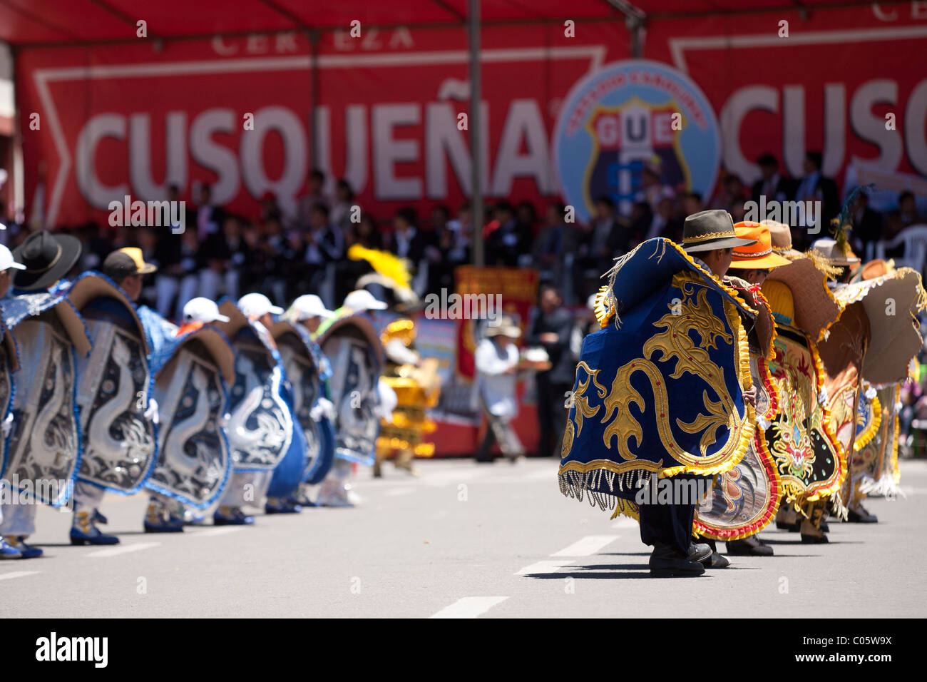 Rows of school children in costume dance before the stand during Puno ...