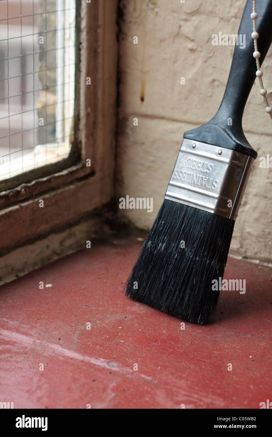 Paint brush propped up by window Stock Photo - Alamy