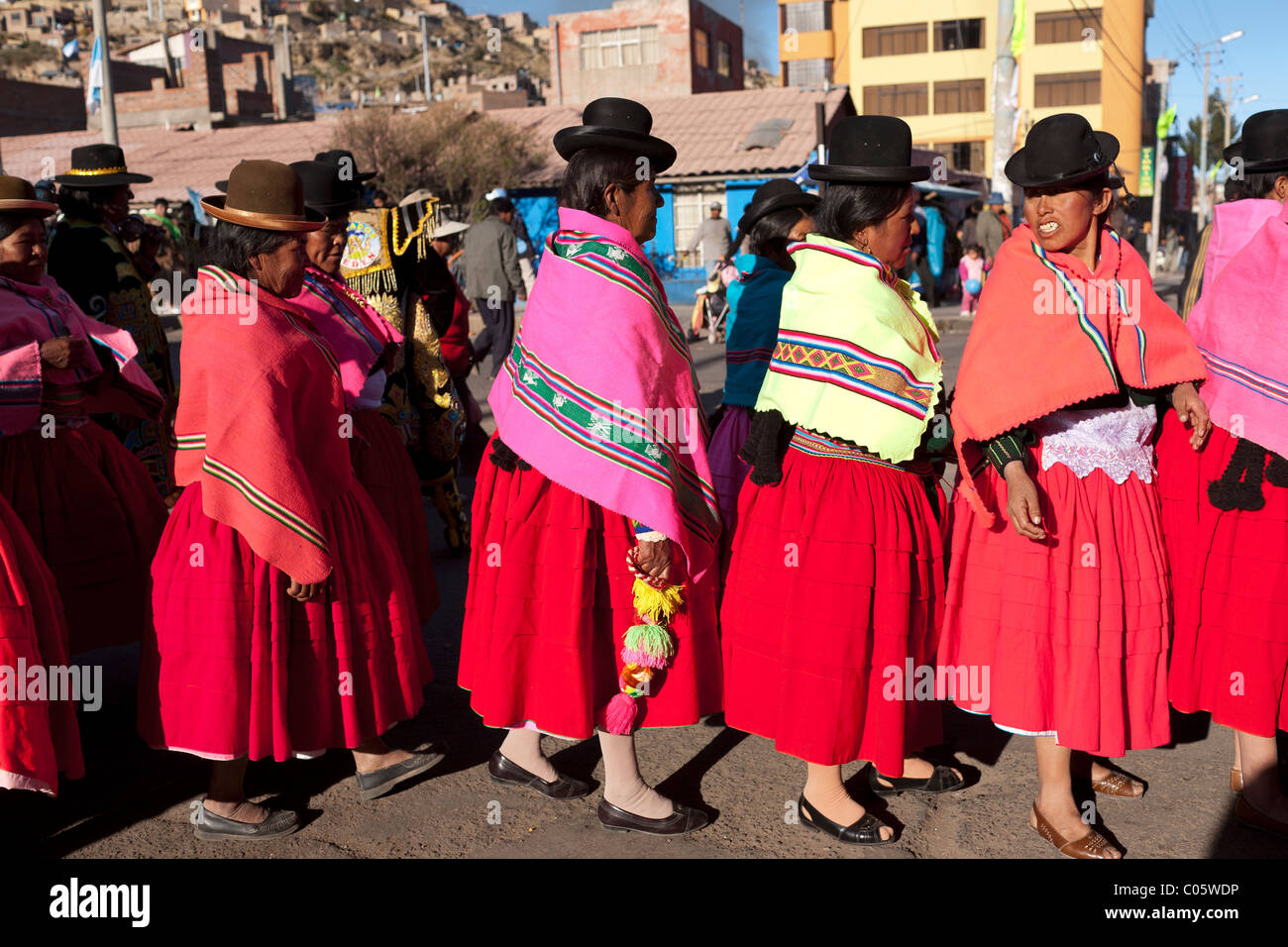 Peruvian women in a line participate in the daily celebrations of Puno ...