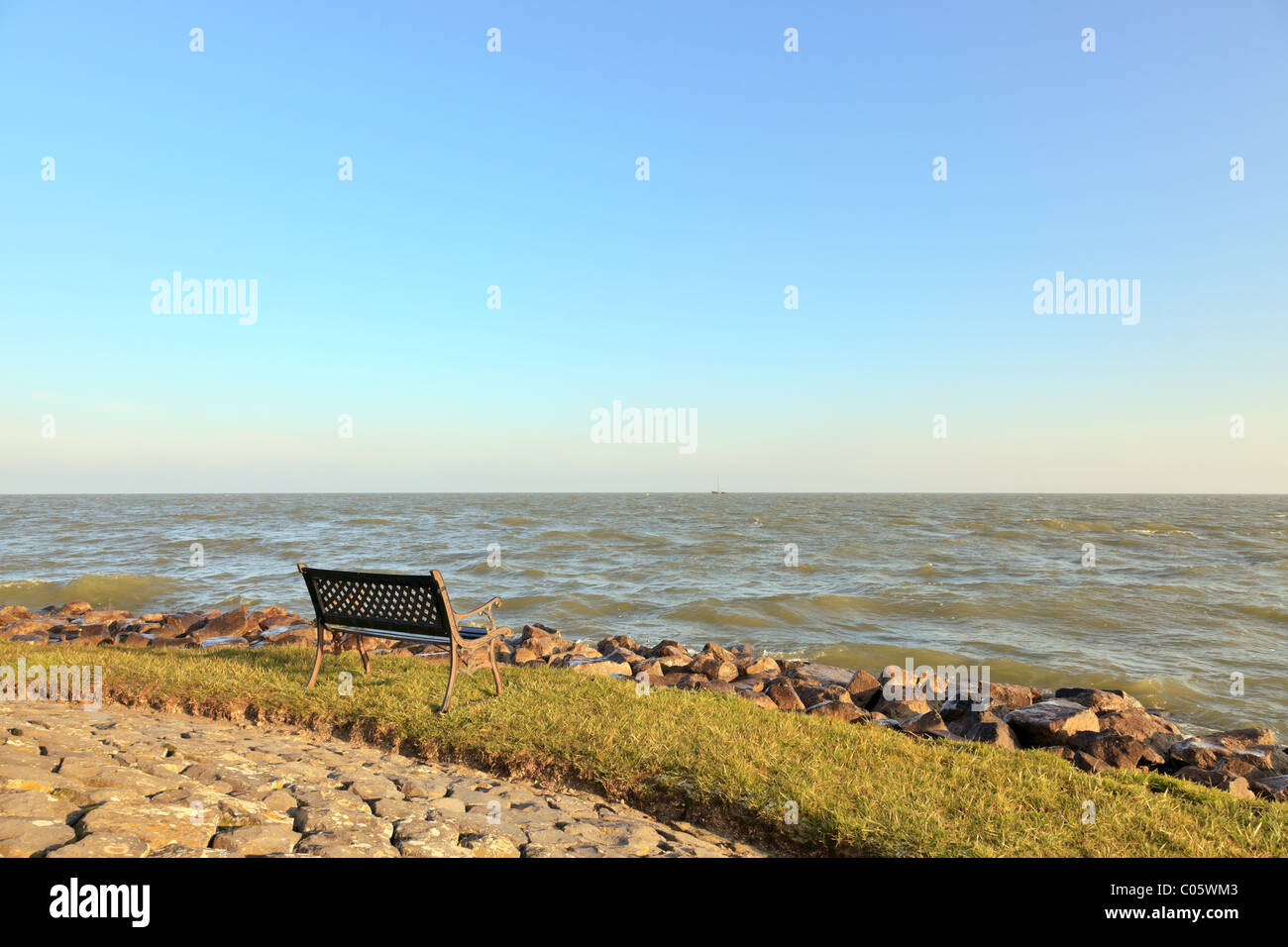 Coastal landscape with rocks and bench Stock Photo - Alamy