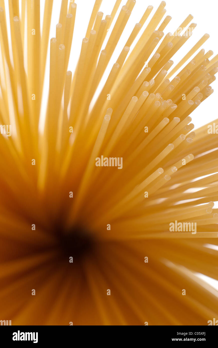 Uncooked spaghetti detail isolated on white background Stock Photo - Alamy