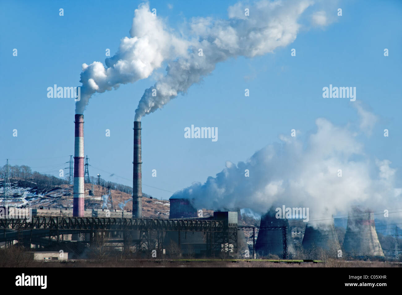 Factory building with pipes and clouds of smoke Stock Photo - Alamy
