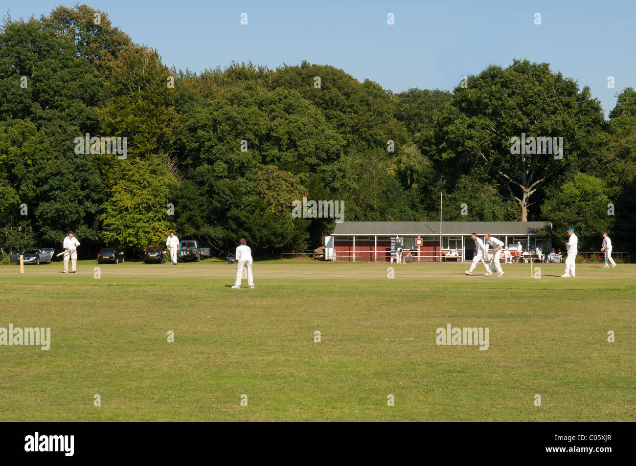 Cricket game being played at Burley in the New Forest Hampshire Stock ...