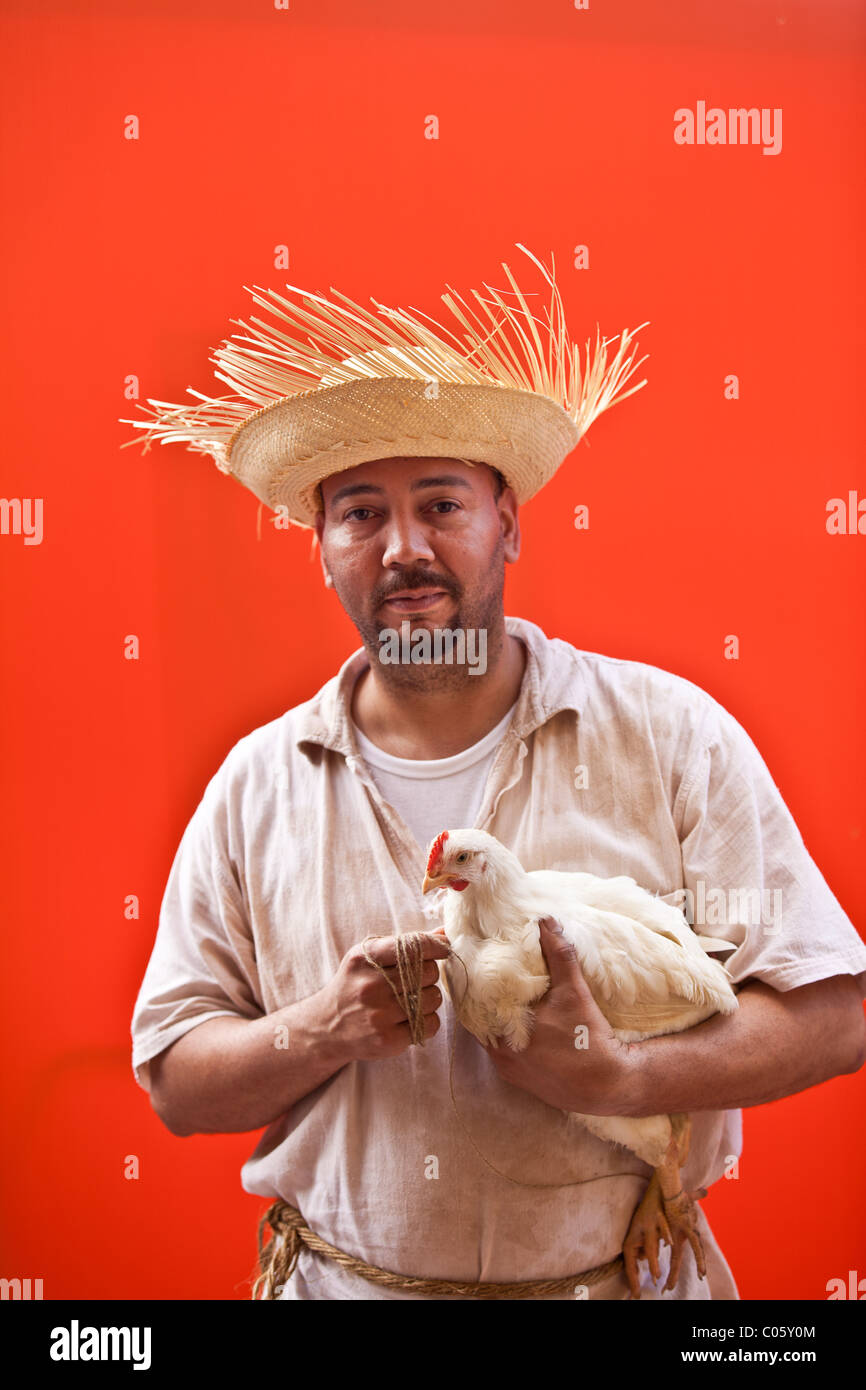 A man dressed in traditional Puerto Rican costume with chicken San ...