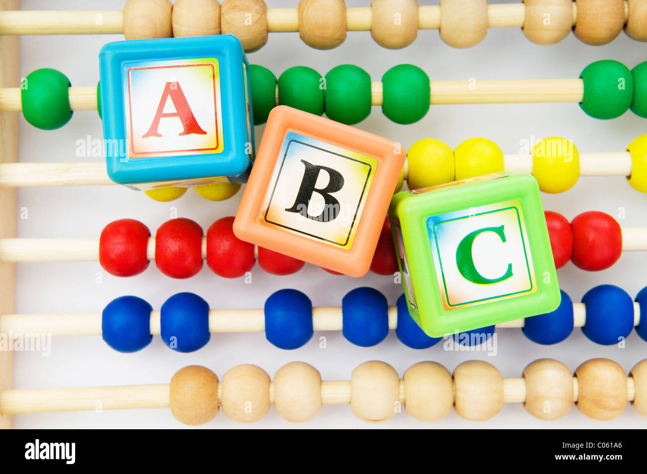 Alphabet blocks and abacus isolated on white Stock Photo - Alamy