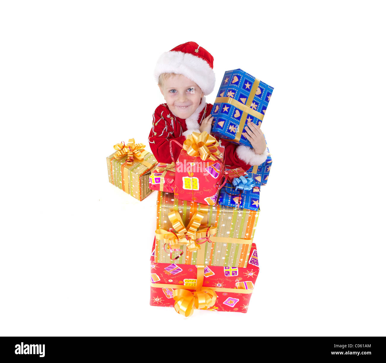 Boy in christmas clothes with presents Stock Photo - Alamy