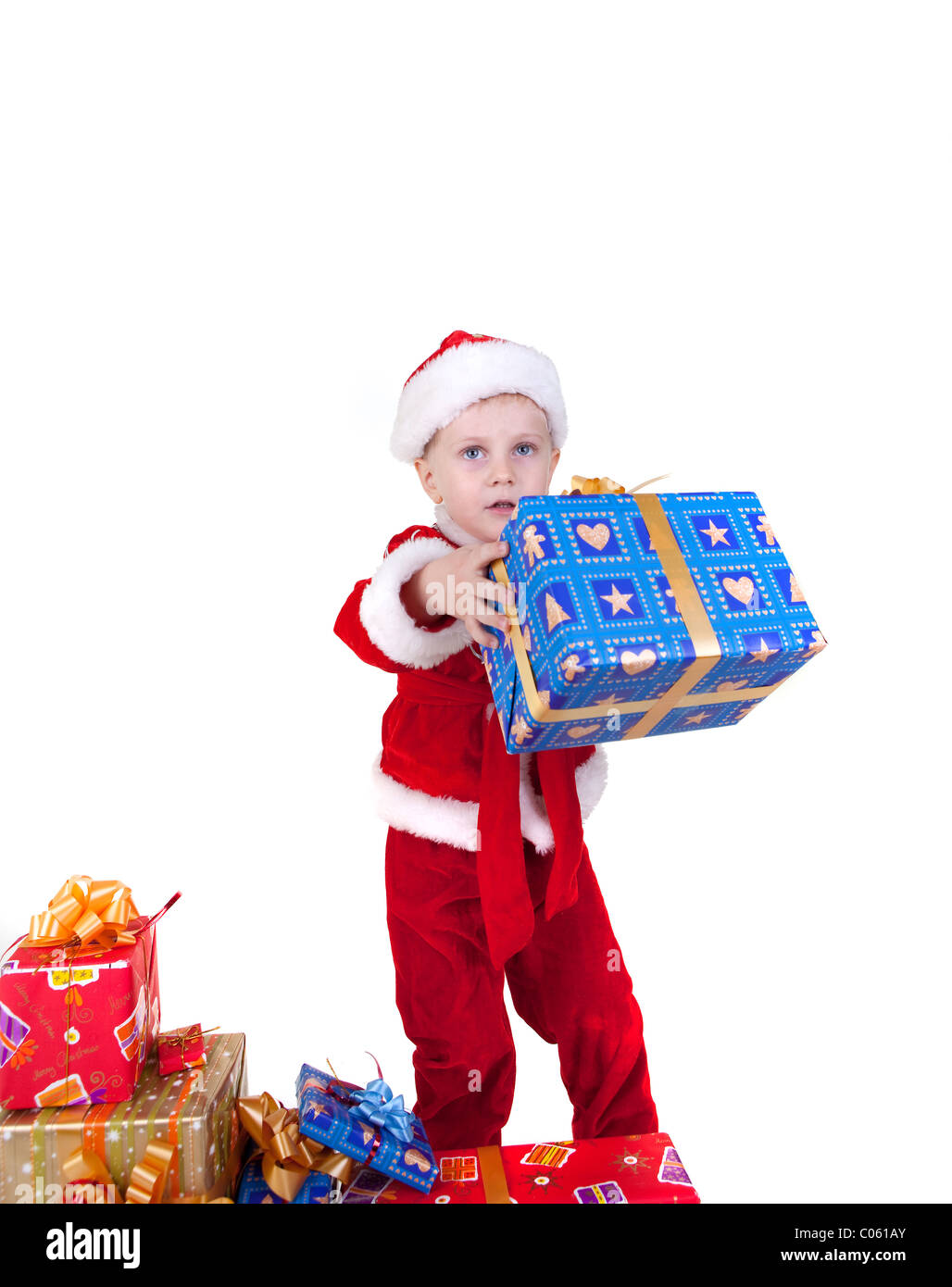 Boy in christmas clothes with presents Stock Photo - Alamy