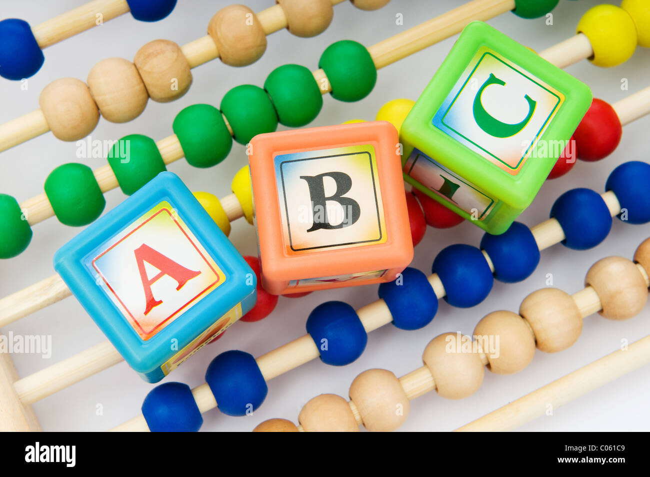 Alphabet blocks and abacus isolated on white Stock Photo - Alamy