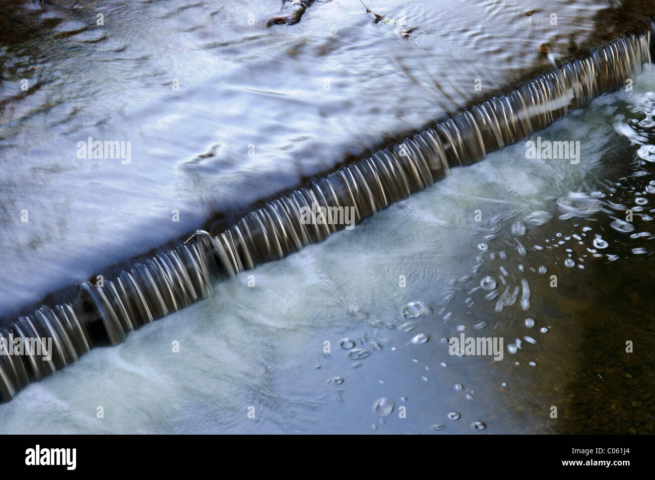 Small water cascade across the frame Stock Photo - Alamy