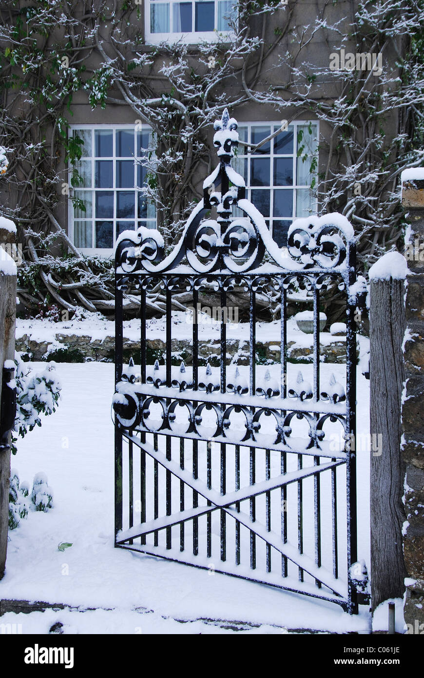 Entrance gate, covered in snow, leading into formal garden after ...