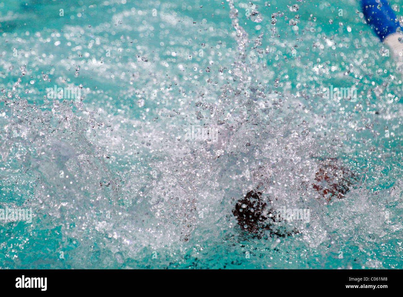 Splash of water as swimmer competes in gala at sports day at school ...
