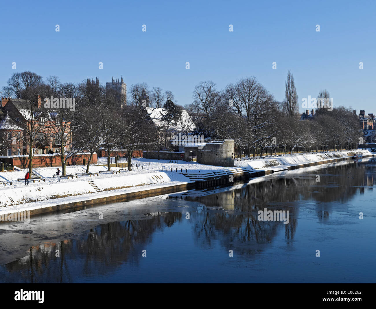 Snow covered riverside walk and Marygate Tower in winter weather scene ...