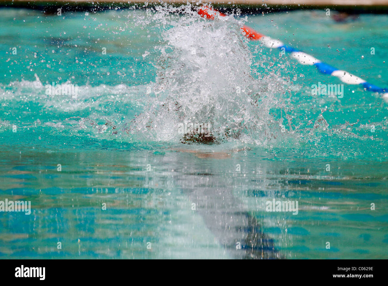 Splash of water as swimmer competes in gala at sports day at school ...