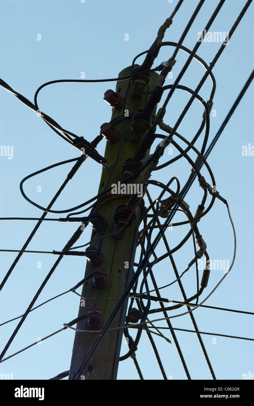 A "telegraph pole" with many overhead utility supply cables or wires on ...