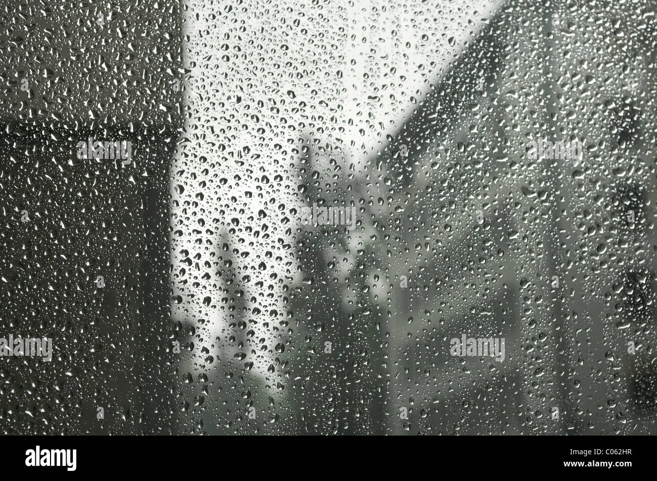 Rain drops on a window pane, blurry buildings in the back Stock Photo ...