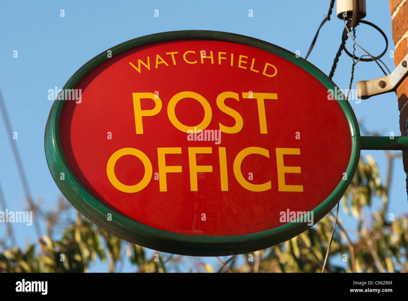 An oval "Post Office" sign outside a rural village post office in the ...