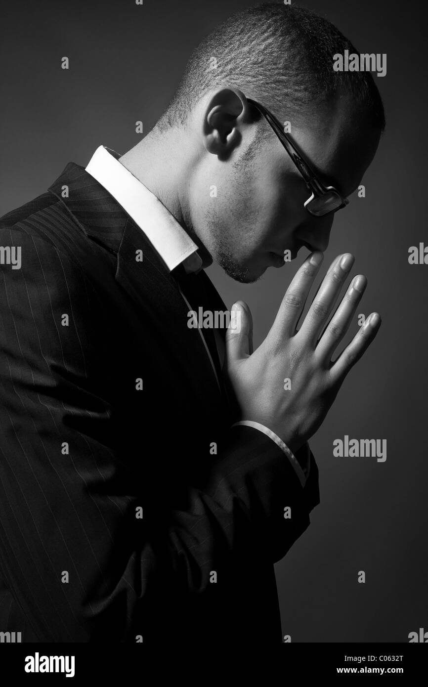 Man in dark suit holding Black and White Stock Photos & Images - Alamy