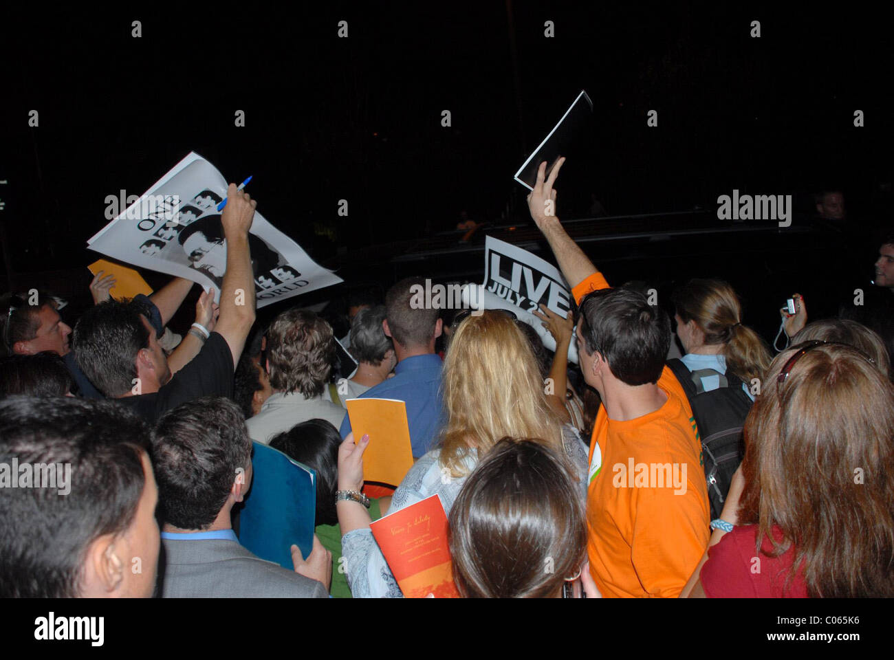 Fans Bono signs autographs for fans as he leaves the Constitution ...