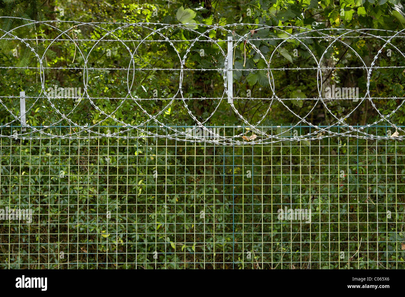 A security fence round an unused UK military warehouse. The fence has ...