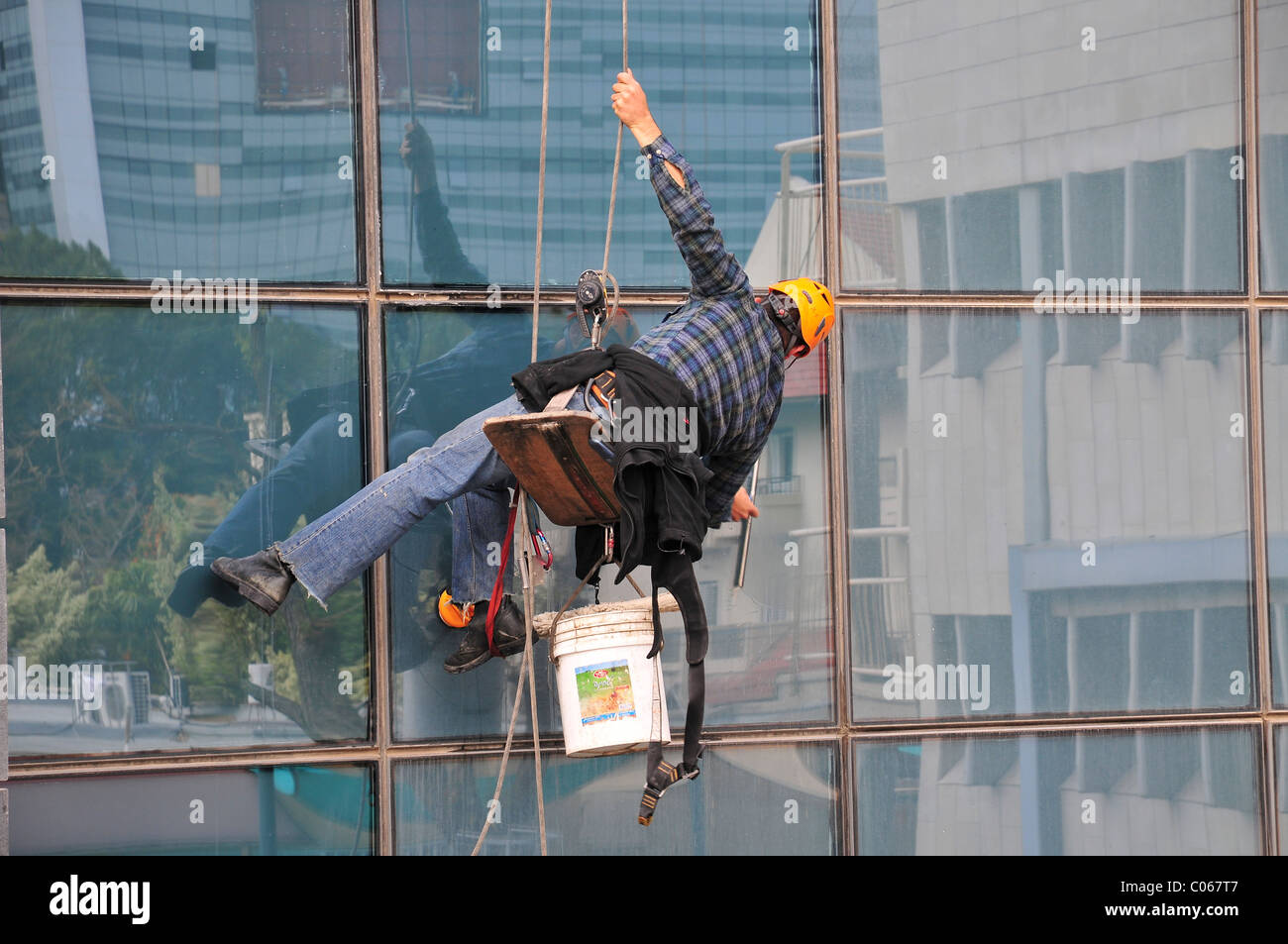 Window washer on side of skyscraper Stock Photo - Alamy