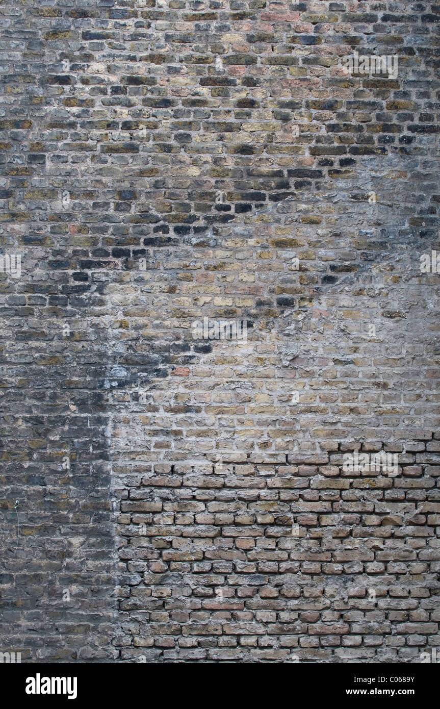 Brick wall with traces of earlier buildings, two roof ridges and ...