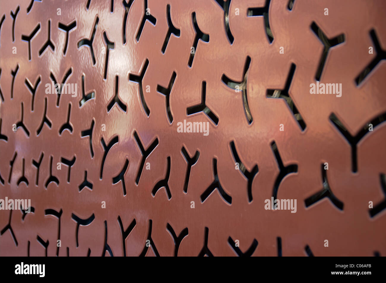 Close up detail of metal punched copper wall Stock Photo - Alamy