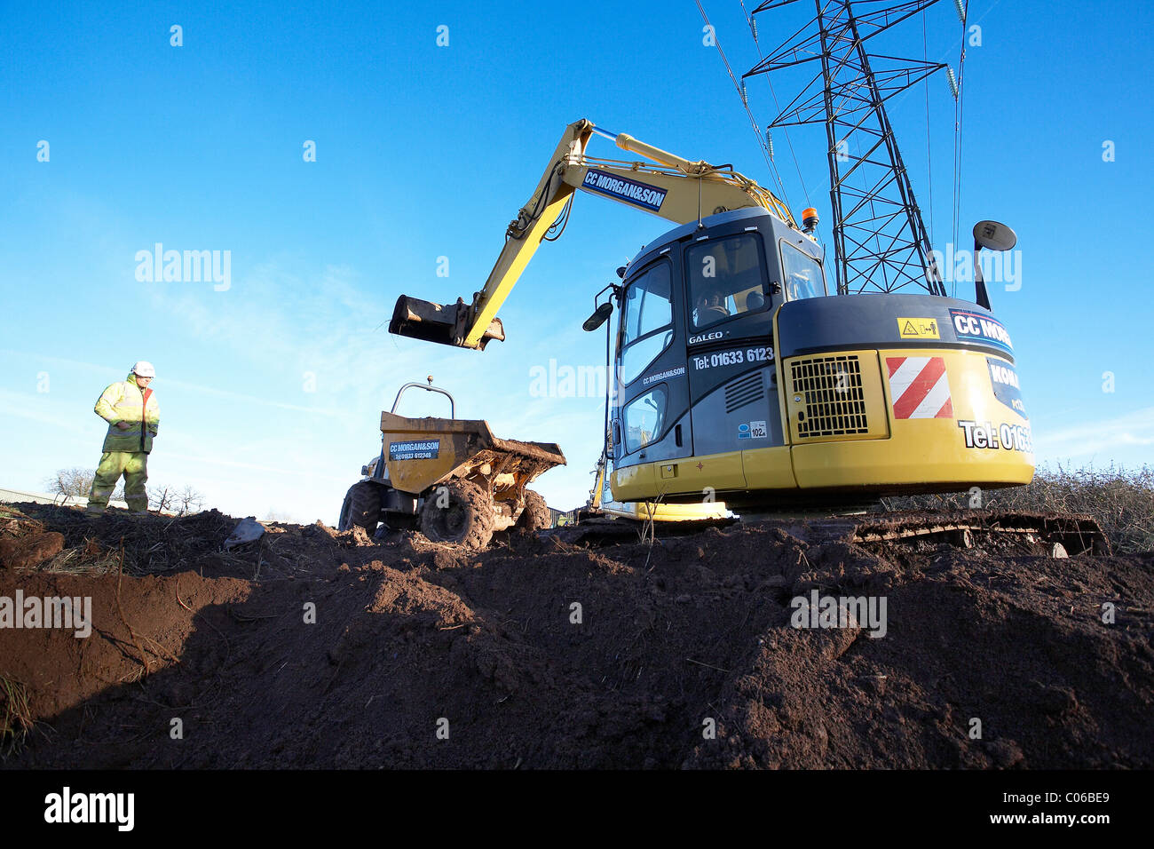 Mechanical diggers excavating earth on a building site Stock Photo - Alamy
