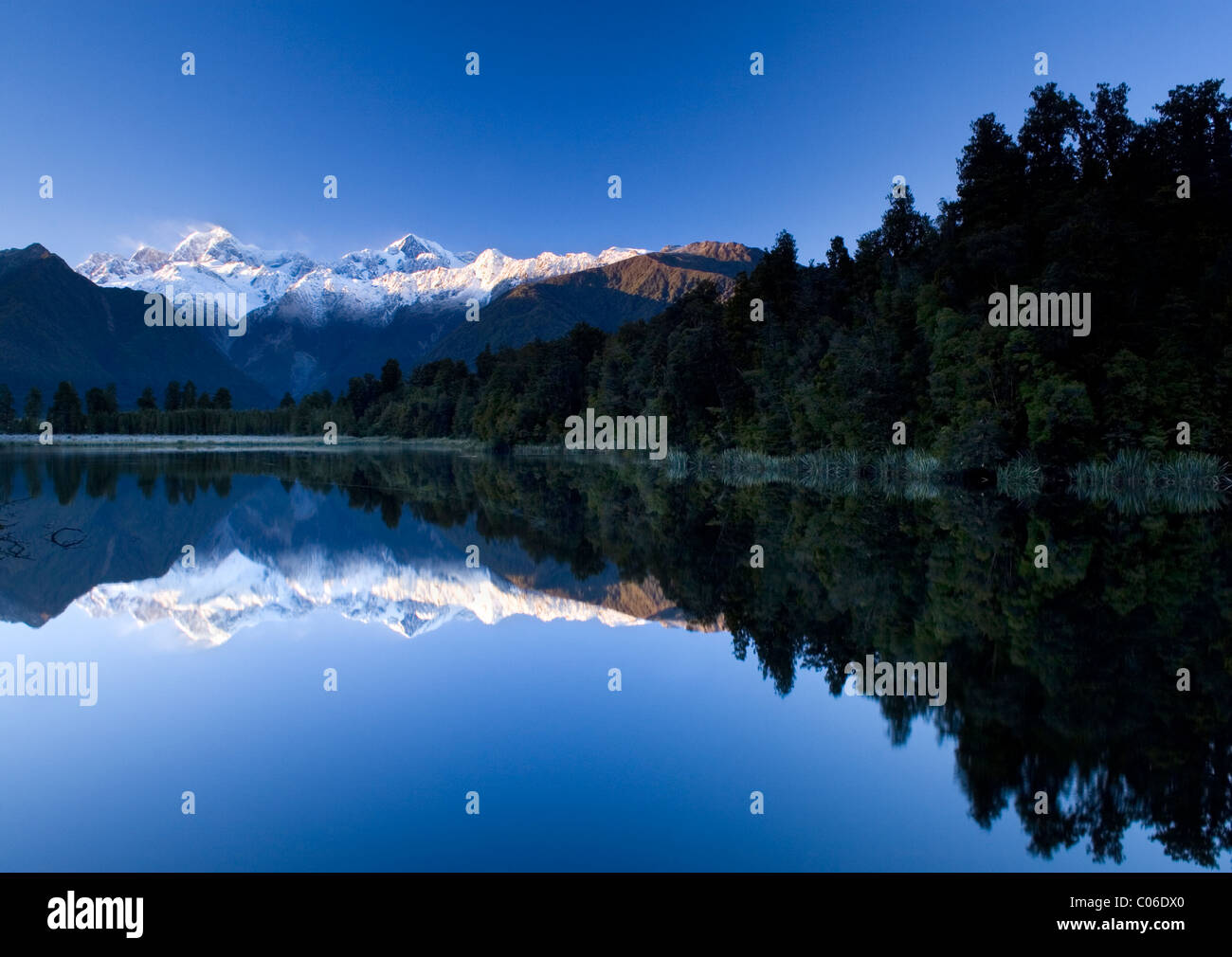 A mirror like reflection of Aoraki Mt Cook reflected in Lake Matheson ...