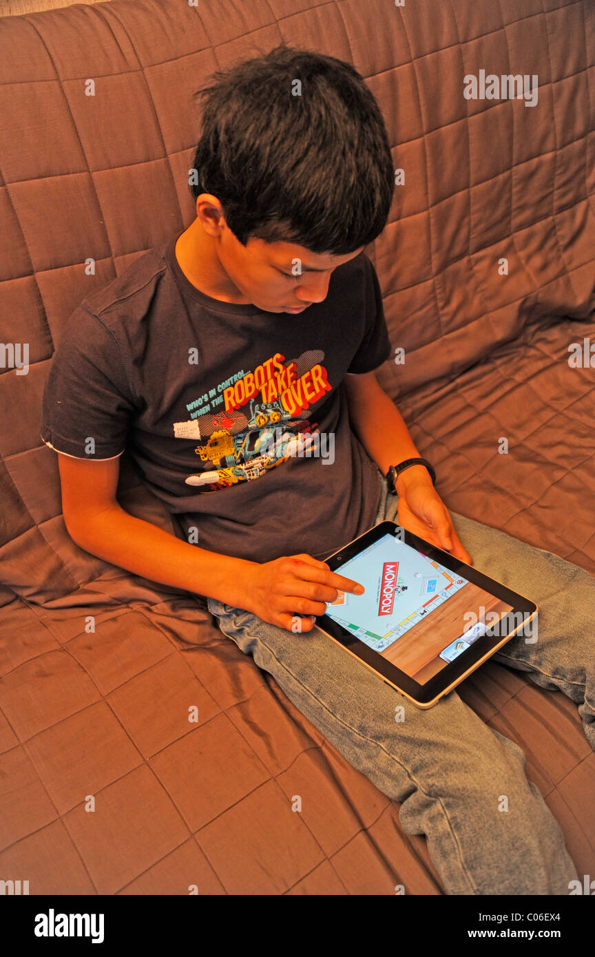 boy play Monopoly with Apple iPad, tablet computer Stock Photo - Alamy