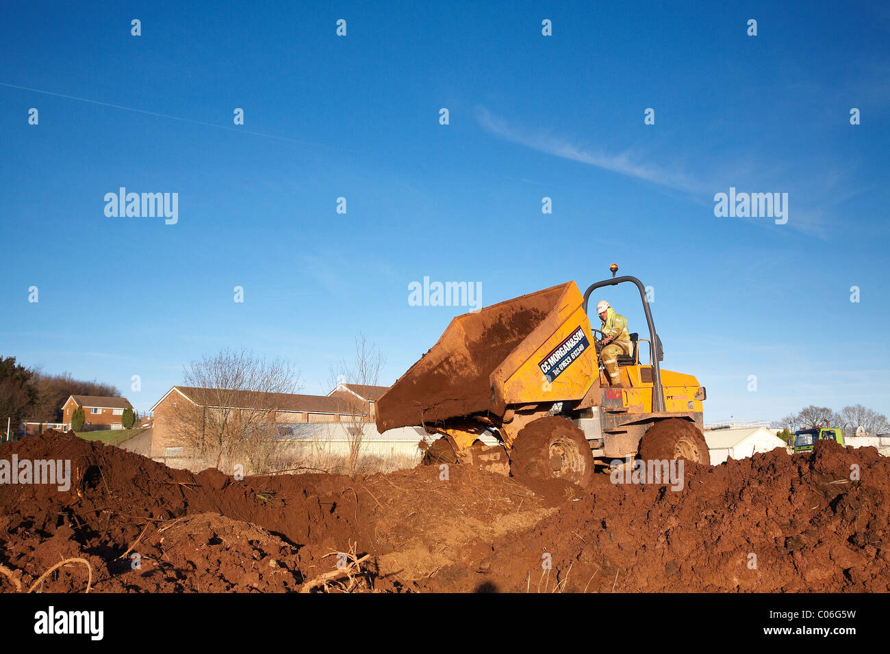Dump truck emptying its bucket full of earth Stock Photo - Alamy
