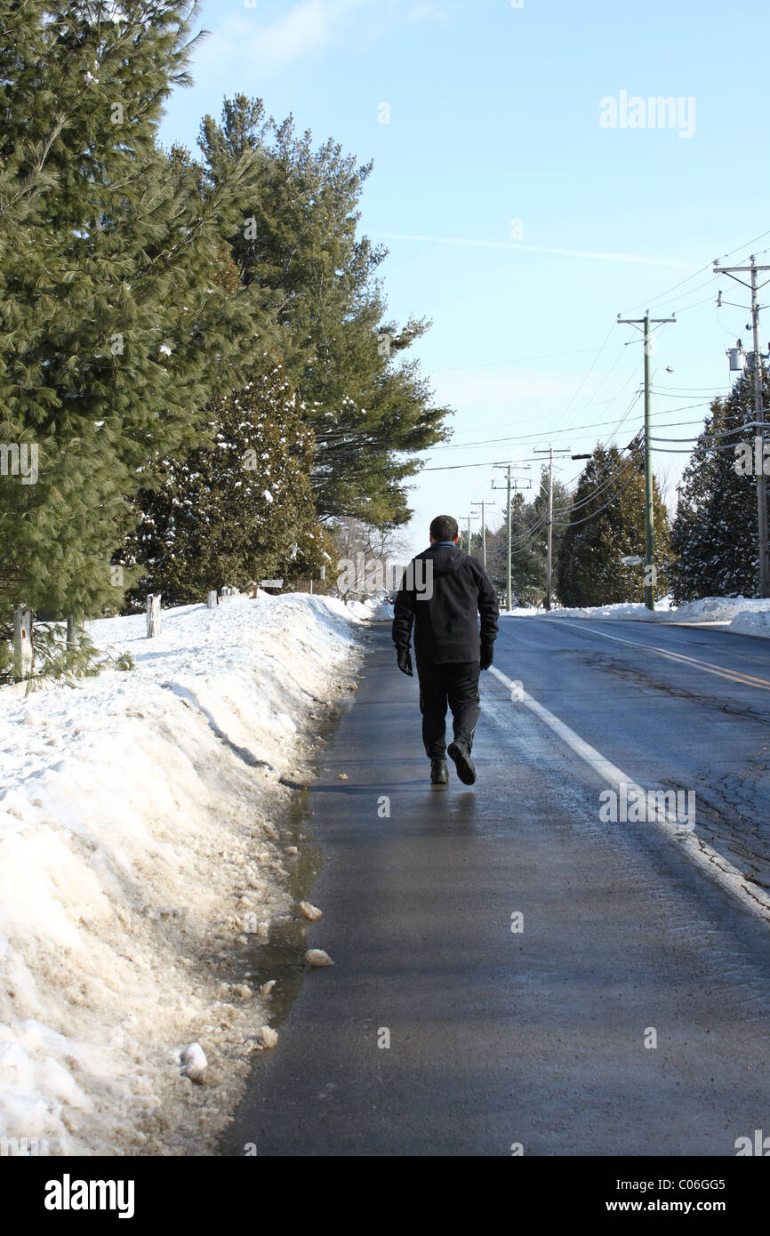 One man walking away leaving Stock Photo - Alamy