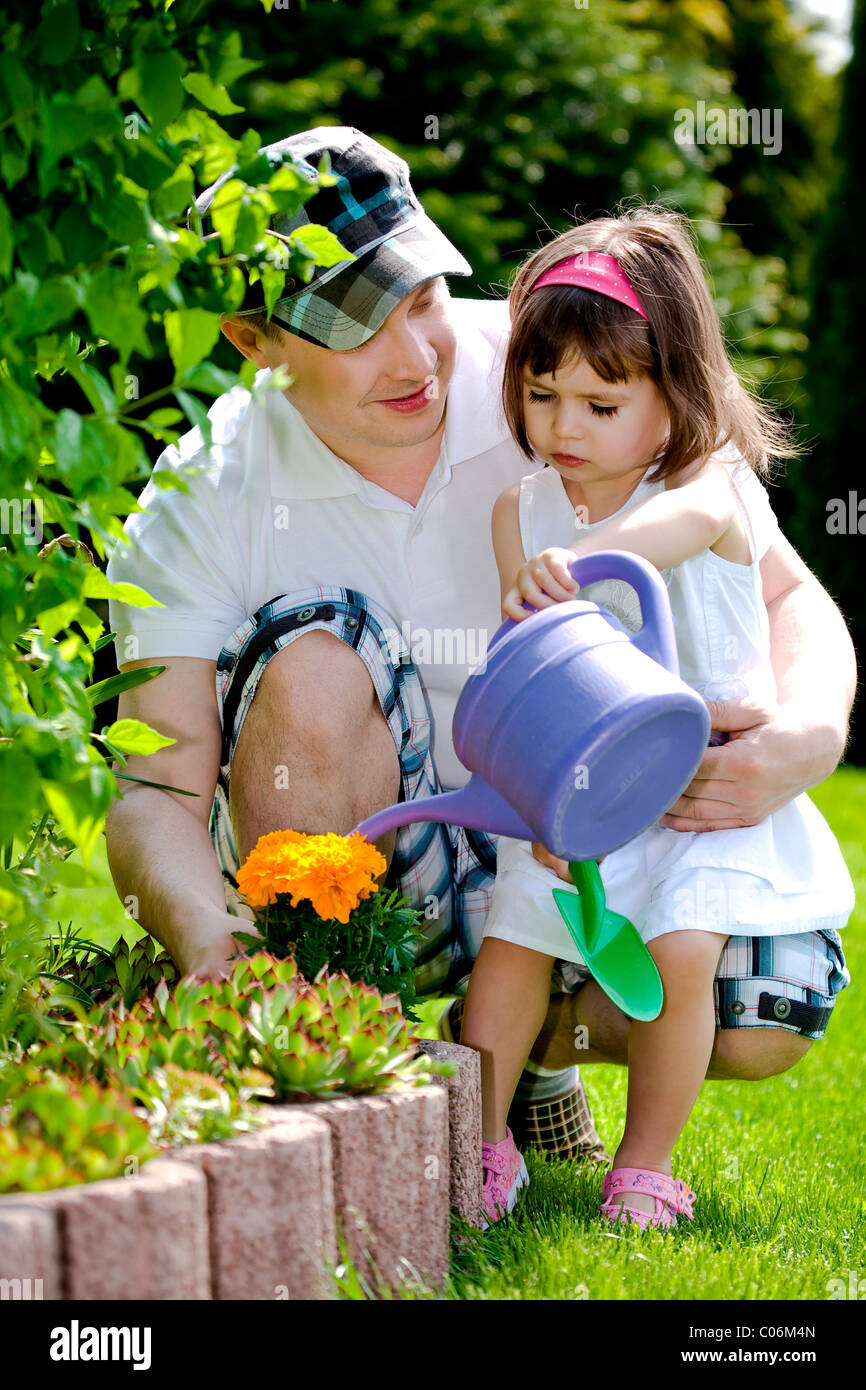 Father and daughter working in the garden Stock Photo - Alamy