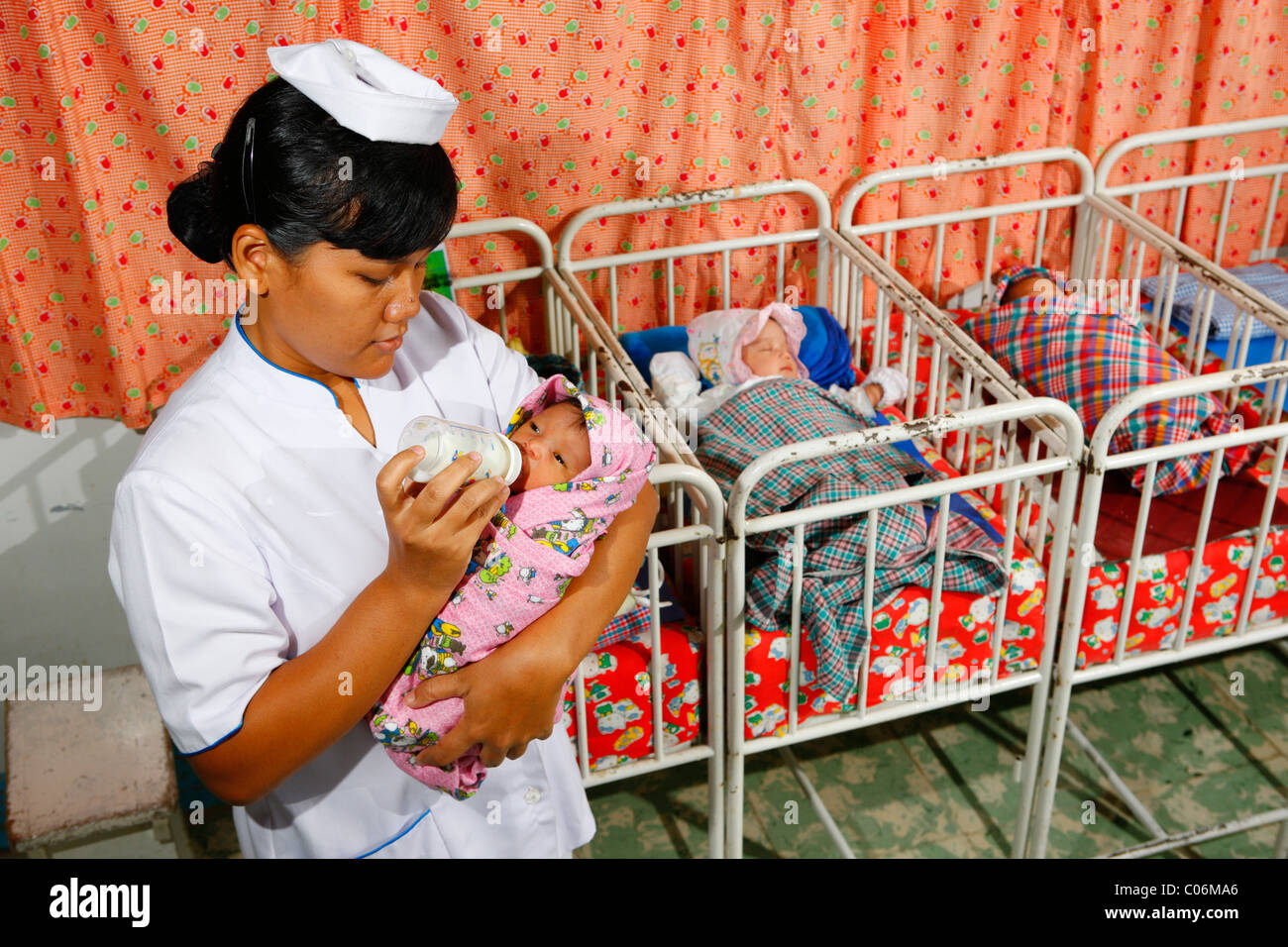Nurse feeding a baby, baby ward, hospital, Balinge, Batak region ...