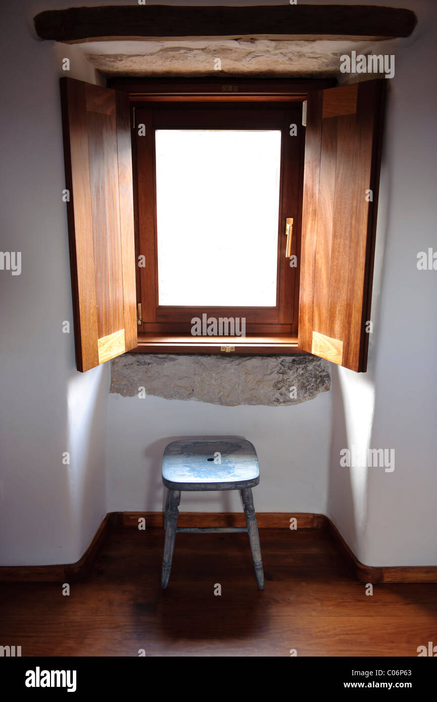 Wooden stool and window Stock Photo - Alamy