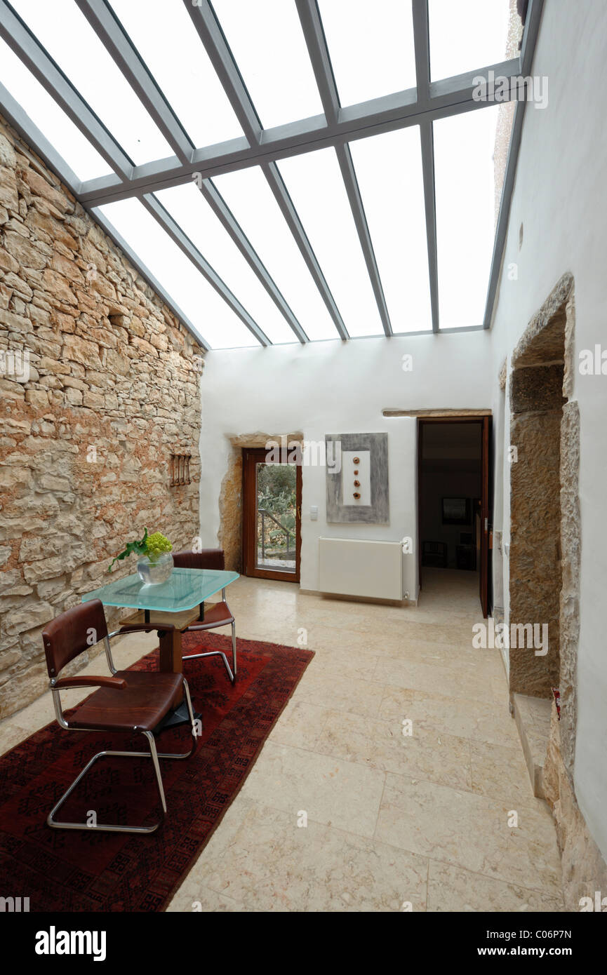 Renovated room with stone wall and glass ceiling skylight Stock Photo ...