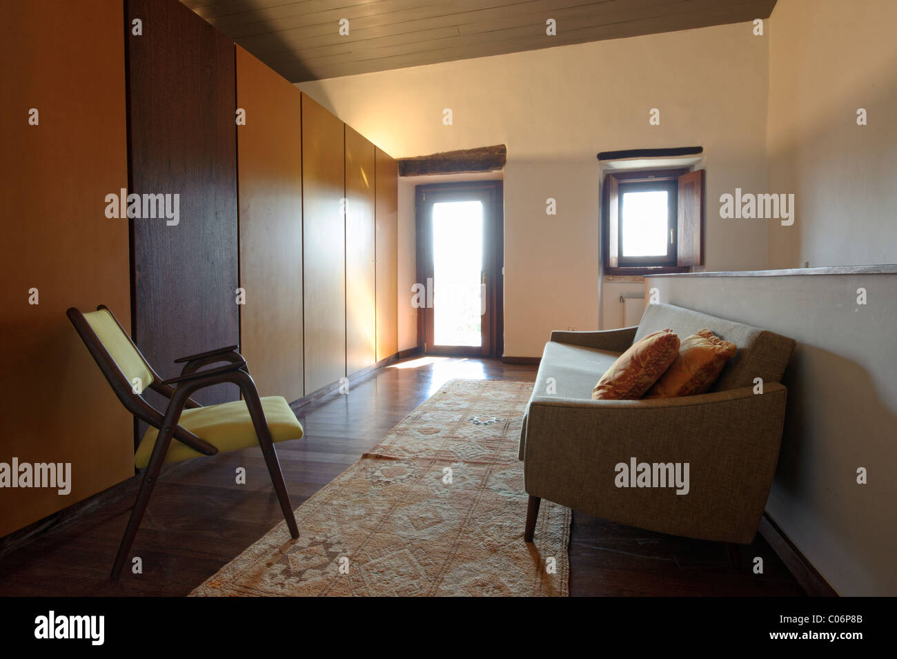 Backlit living room with sofa and chair Stock Photo - Alamy