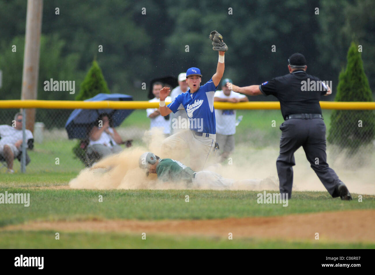 Third baseman reacts to a safe call from the base umpire as the runner ...