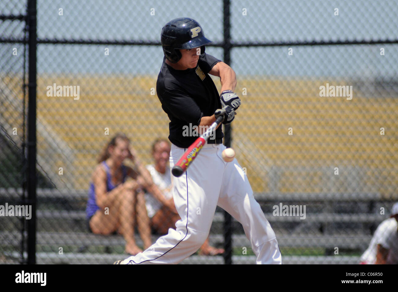 Batter makes contact and drives in a run during a high school baseball ...