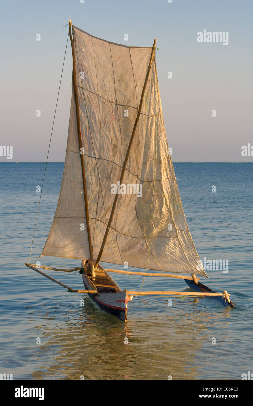 Malagasy outrigger pirogue with makeshift sails Stock Photo - Alamy
